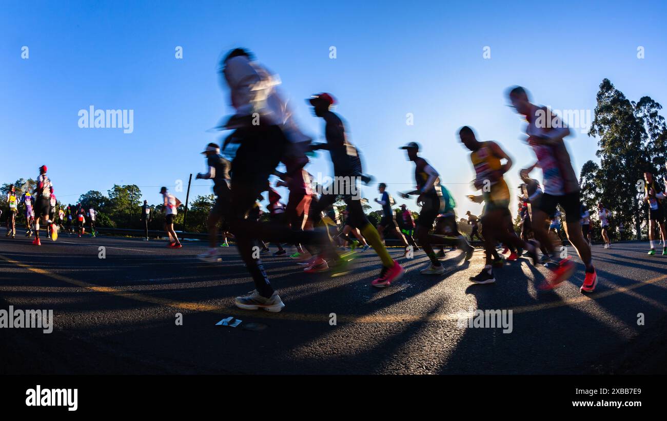 Marathon runners motion speed blurs silhouetted morning dawn sunrise ...
