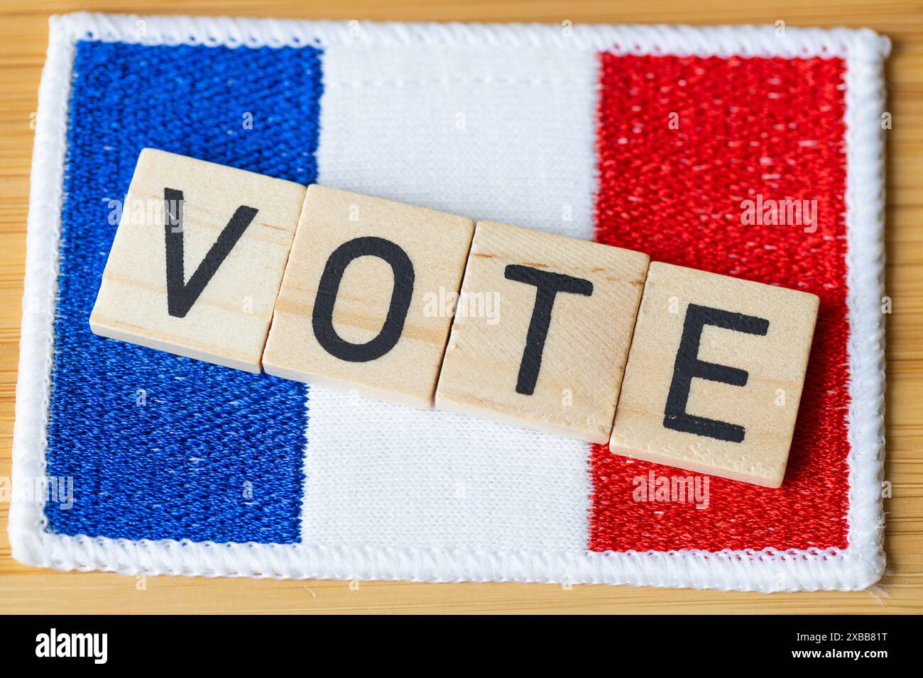 Voting in France. The flag of France and wooden blocks with the word ...