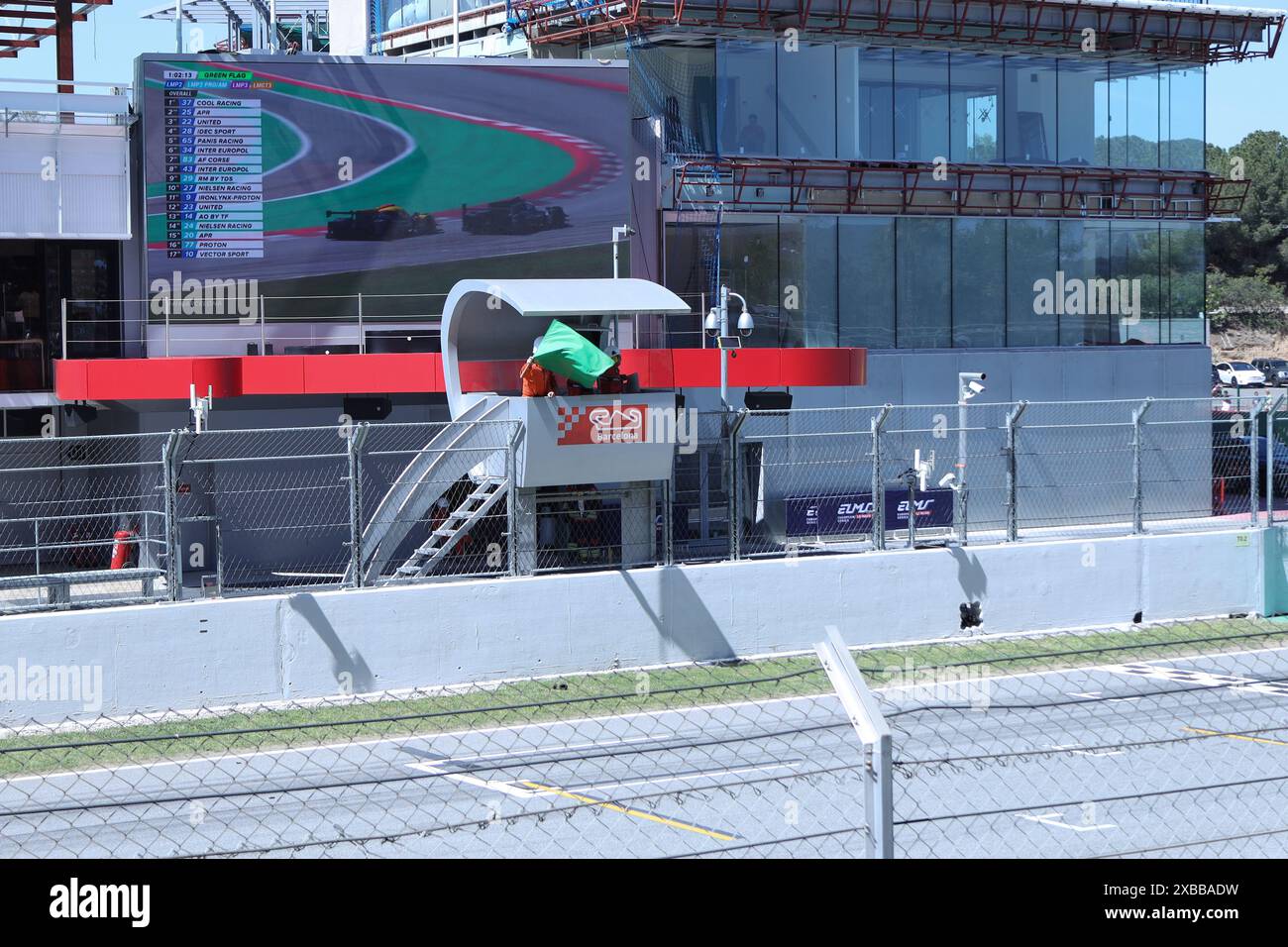 Green flag being waved by race Marshall at the 2024 Barcelona European ...