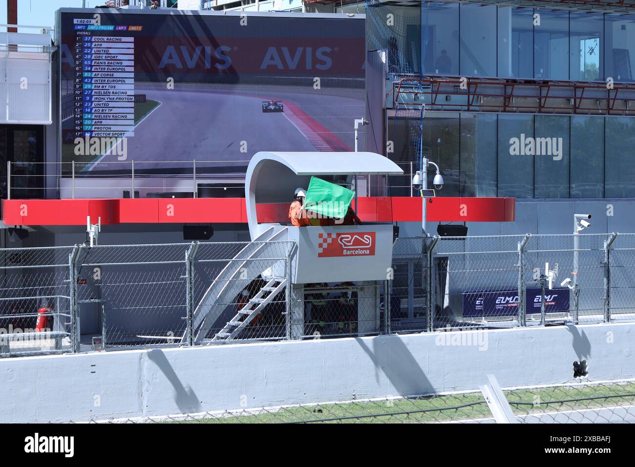 Green flag being waved by race Marshall at the 2024 Barcelona European ...