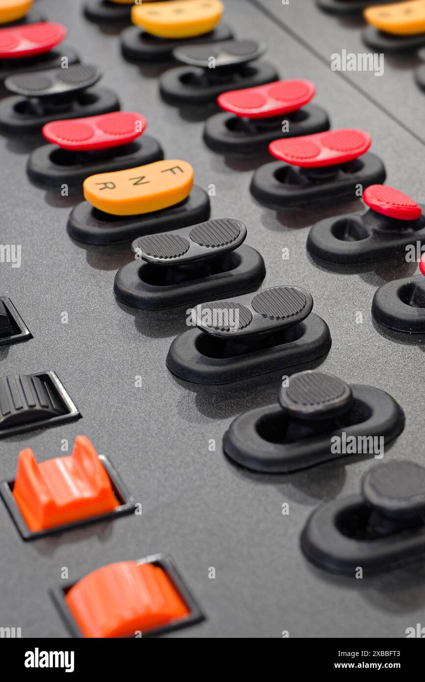 Black control panel with accorted buttons and switches. Abstract ...