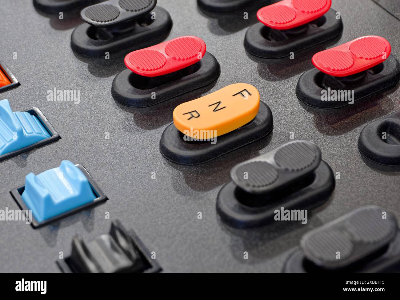 Black control panel with accorted buttons and switches. Abstract ...