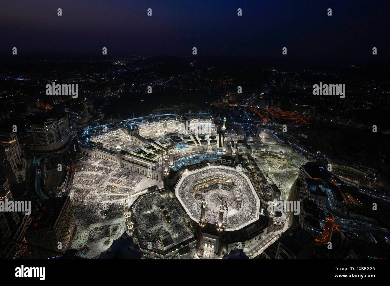 Muslim pilgrims circumambulate the Kaaba, the cubic building at the ...