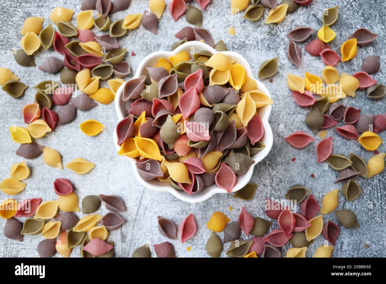 Colorful pasta background. Top view of five colors pasta shells on ...