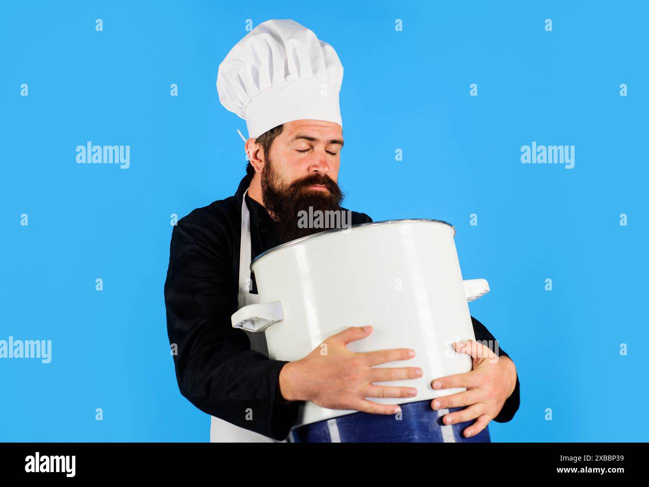 Cooking and culinary. Professional chef in uniform with big cooking pot ...