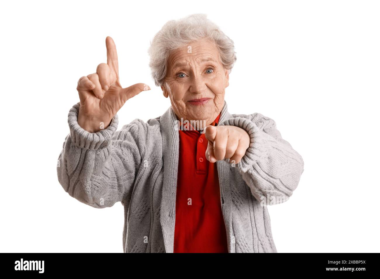 Senior woman showing loser gesture on white background Stock Photo - Alamy
