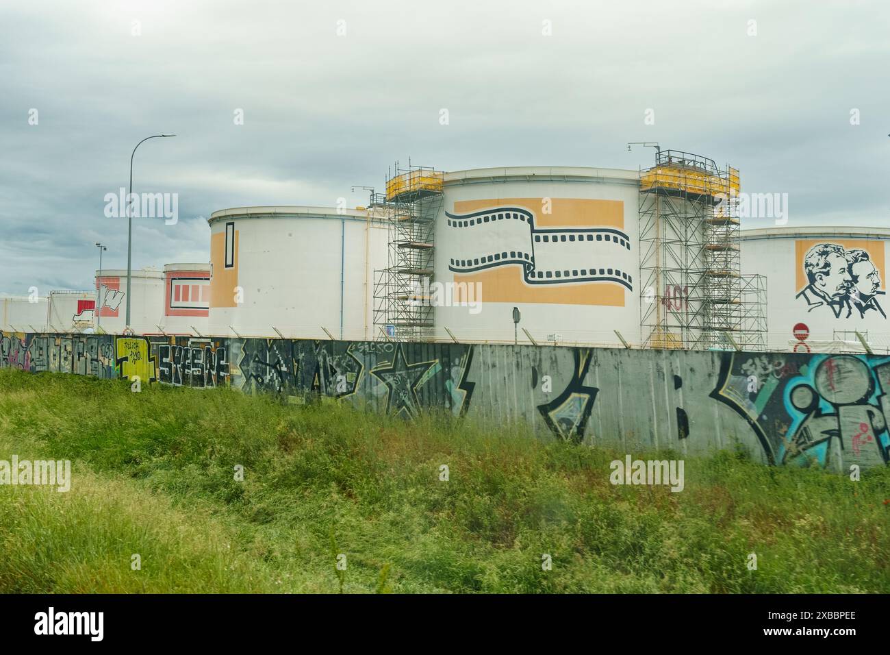 Lyon, France - May 7, 2023: Industrial oil tanks with murals and ...