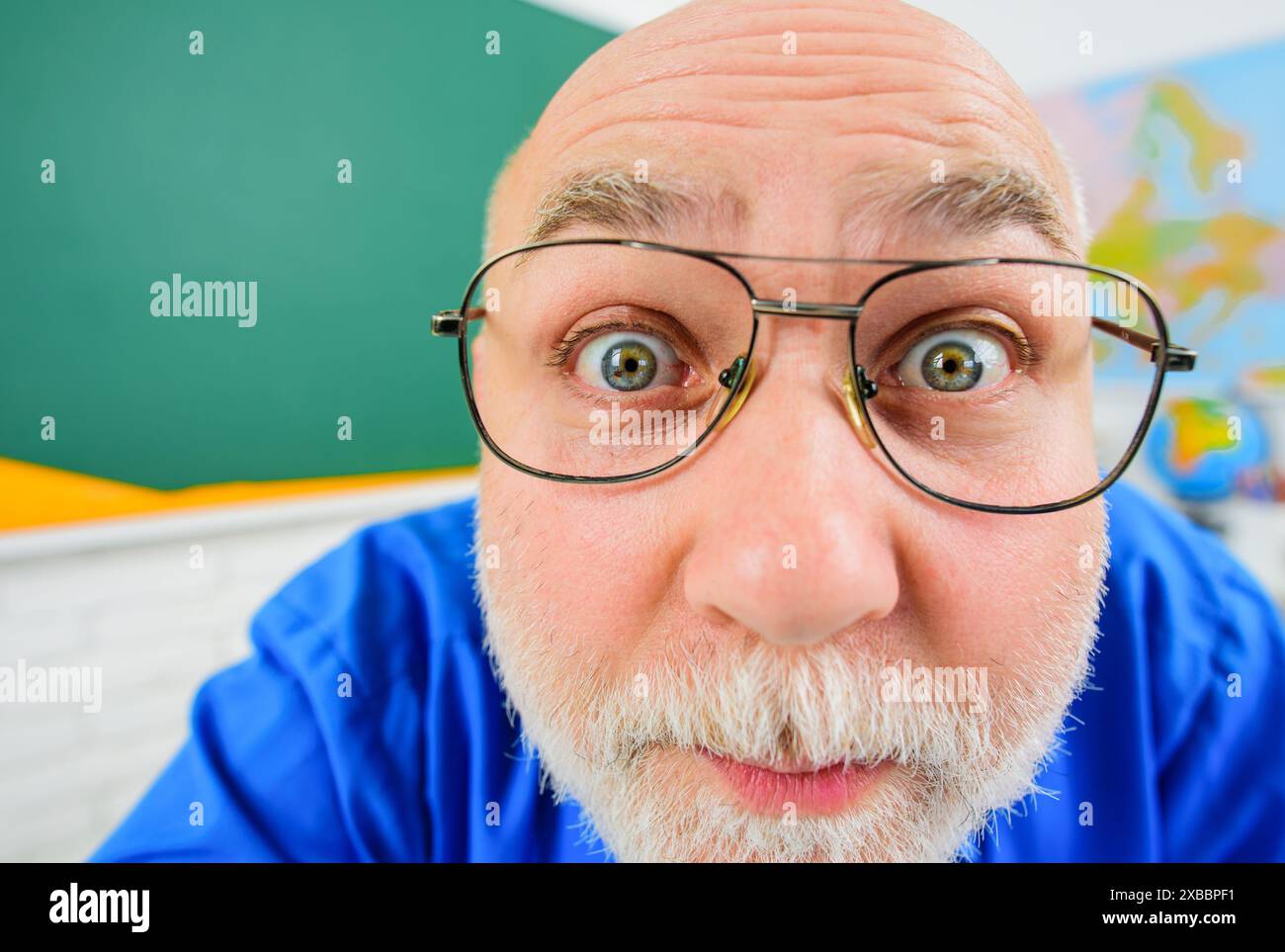 Closeup portrait of funny male school teacher in classroom. Back to ...