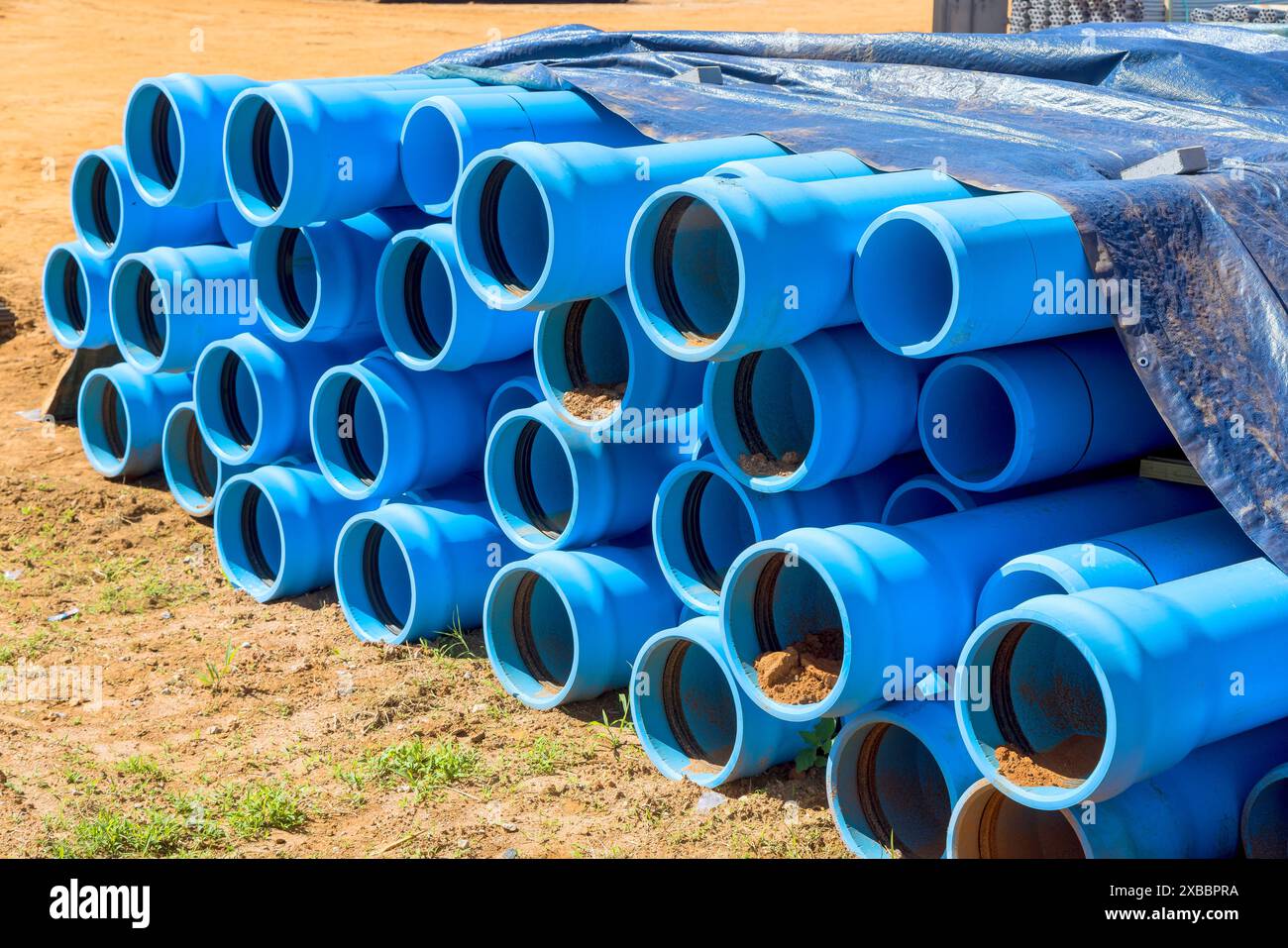 Blue PVC pipes are visible on construction site for laying pipe water ...