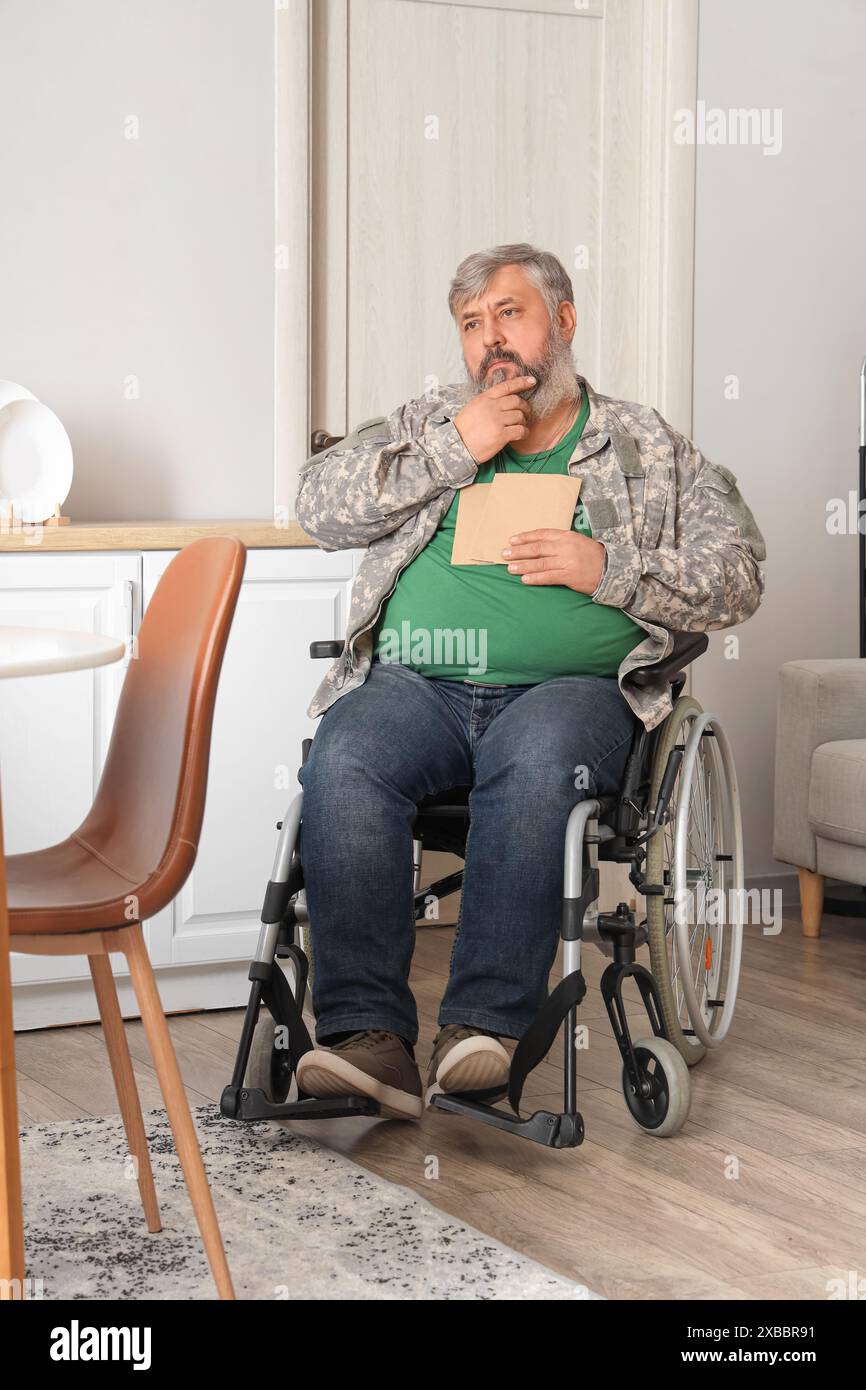 Portrait of sad senior veteran in wheelchair with letters at home Stock ...