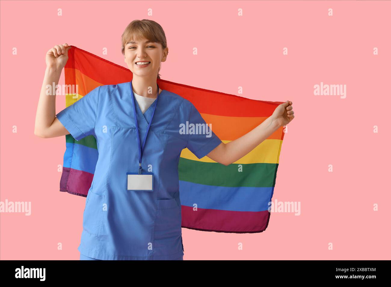 Female doctor with LGBT flag on pink background Stock Photo - Alamy