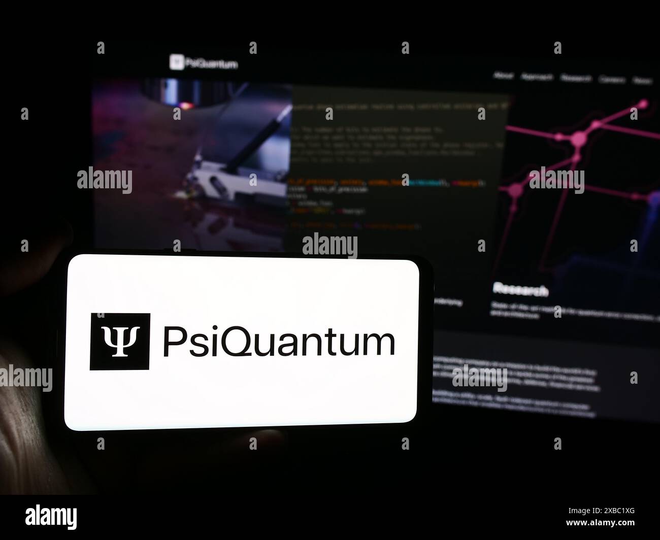 Person holding mobile phone with logo of American quantum computing ...