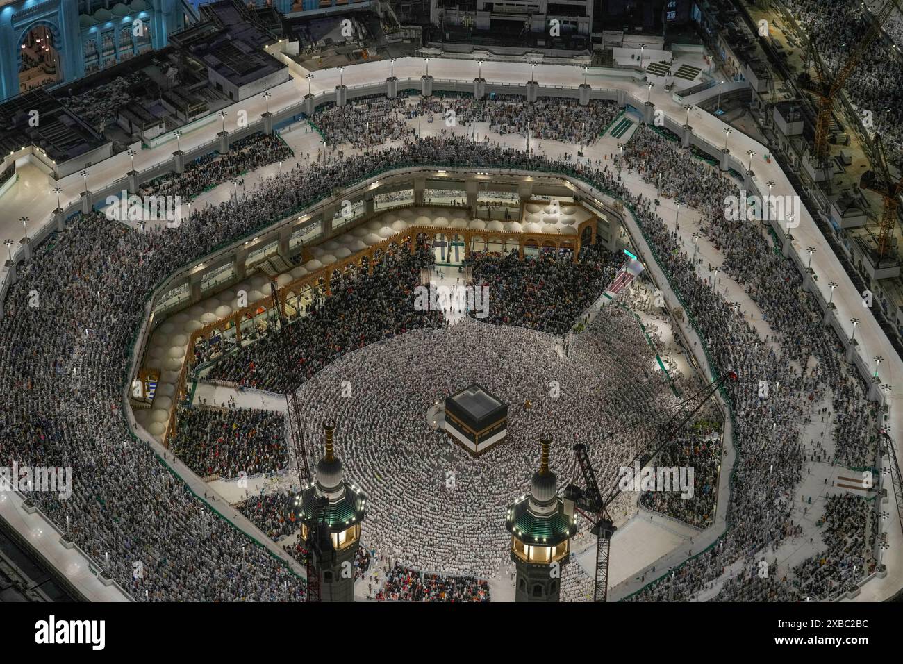 Muslim pilgrims circumambulate the Kaaba, the cubic building at the ...
