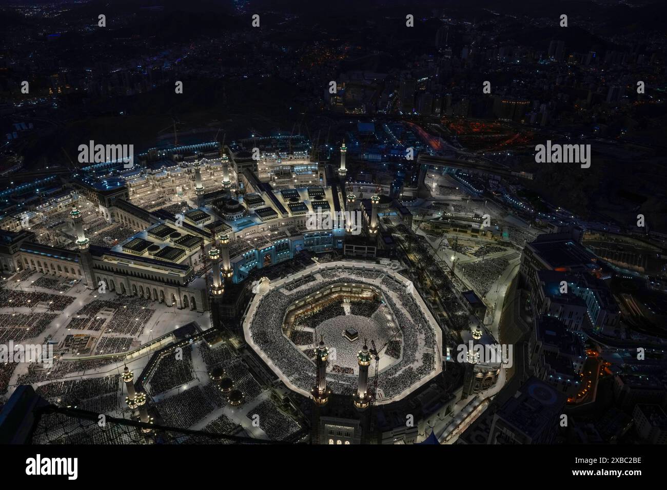 Muslim pilgrims circumambulate the Kaaba, the cubic building at the ...