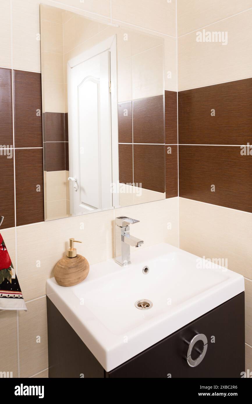 Clean hotel bathroom sink and faucet and bottle. Vertical shot Stock ...
