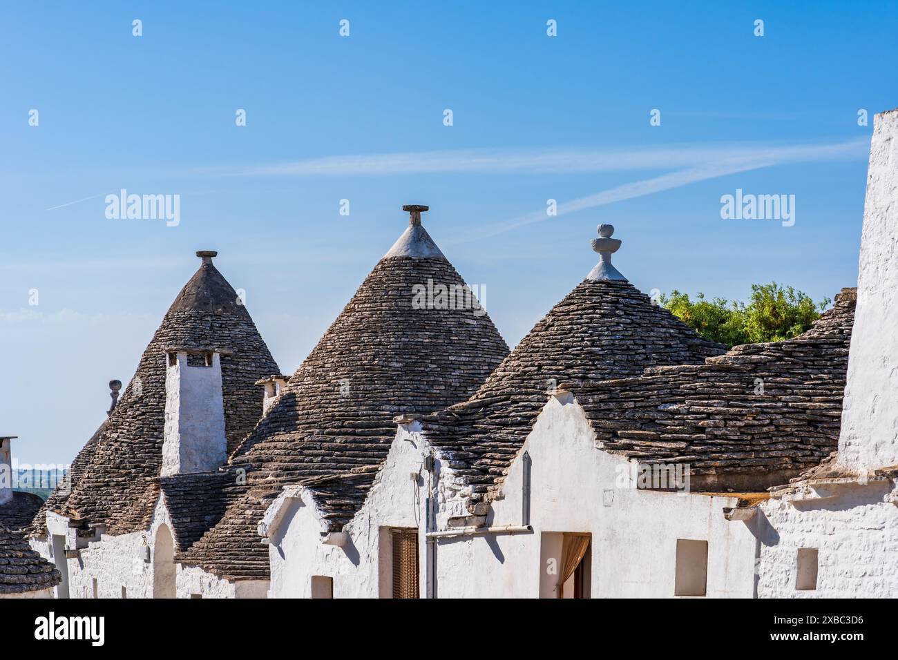 Conical roofs of the famous old dry stone trulli houses in Alberobello ...