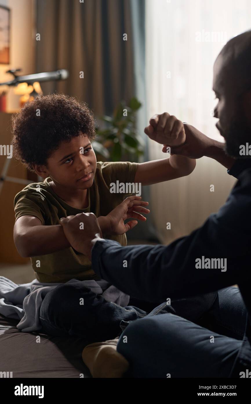 Vertical portrait of young teenage boy fighting with father ...