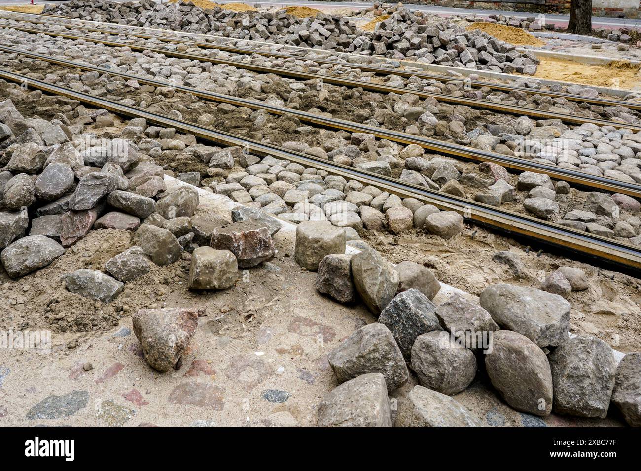 Paving of the tram tracks and street with historic natural granite ...