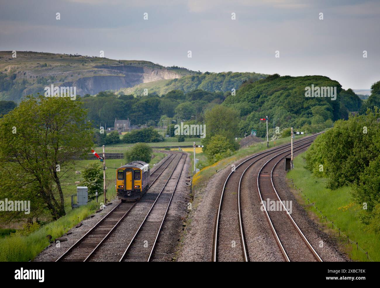 Northern Rail class 150 DMU train 150214 passing the semaphore signals at Settle junction ...