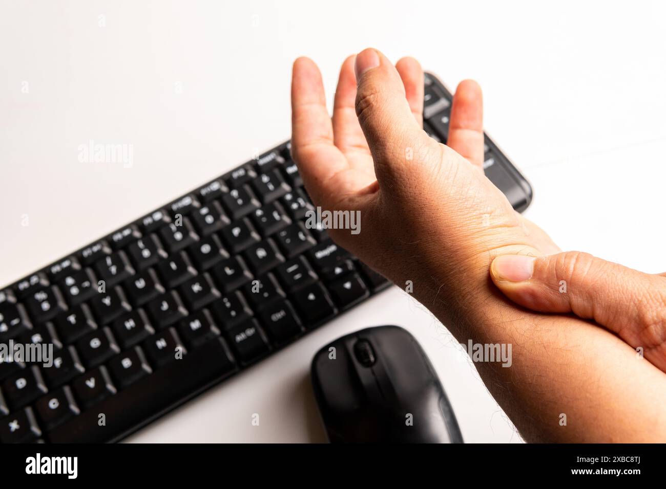 Business man at computer and feeling wrist pain or carpal tunnel pain ...