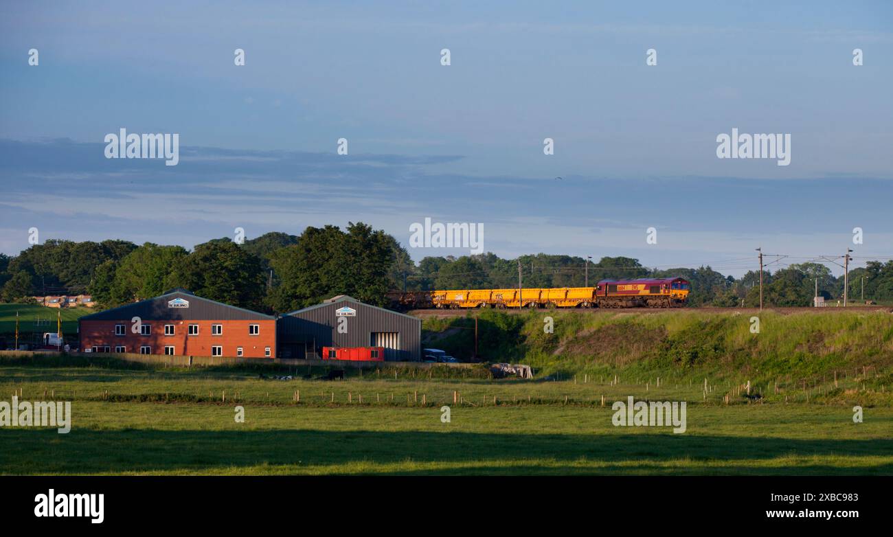 DB Schenker class 66 diesel locomotive in EWS livery hauling freight a ...