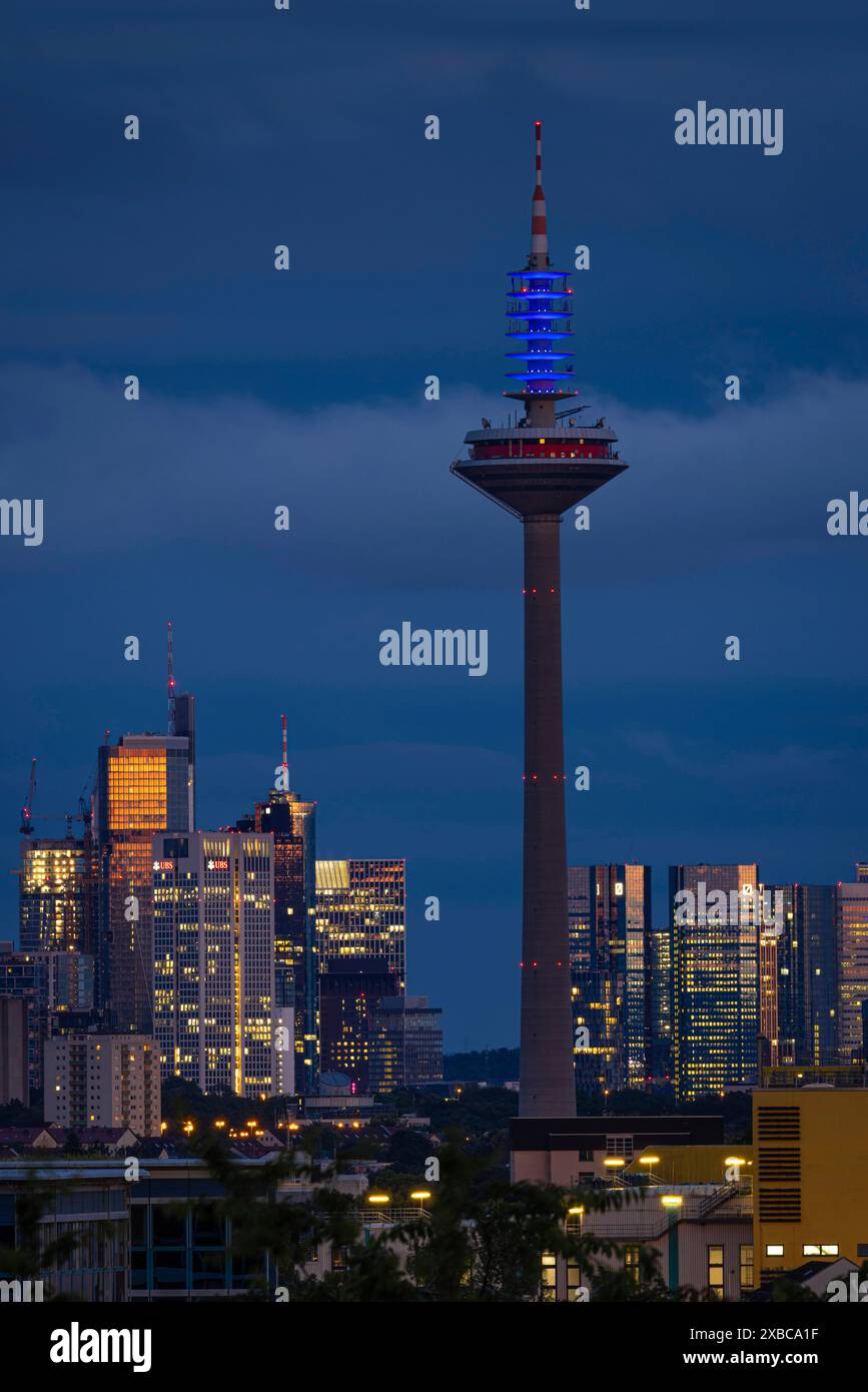 The top of the Europe Tower in Frankfurt am Main shines in the blue of ...
