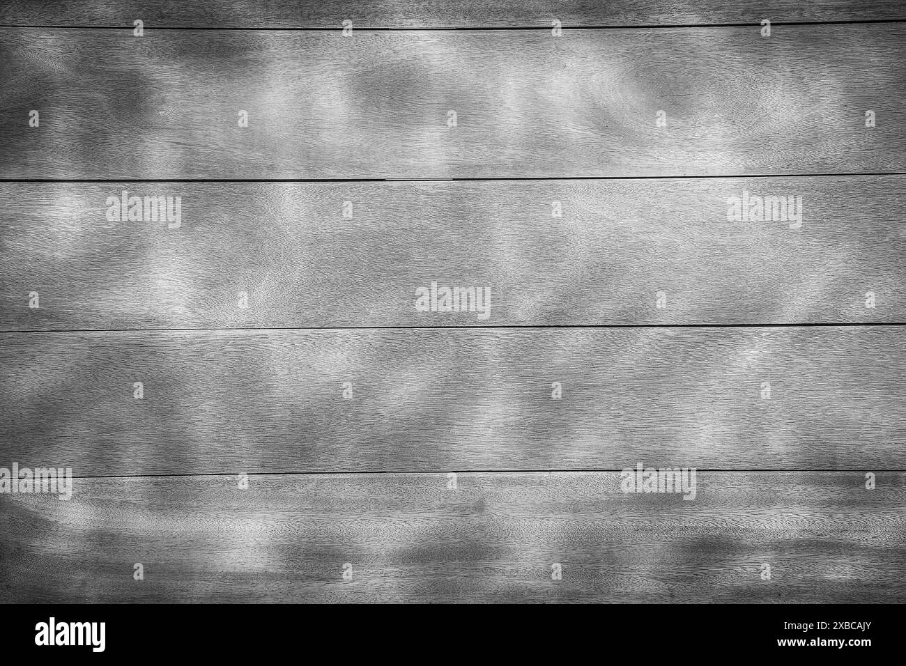 Wooden planks with shadowy light patterns creating a calm and subtle ...
