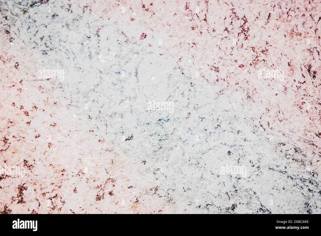 Abstract texture with marbled white, red, and gray colors on a rough ...