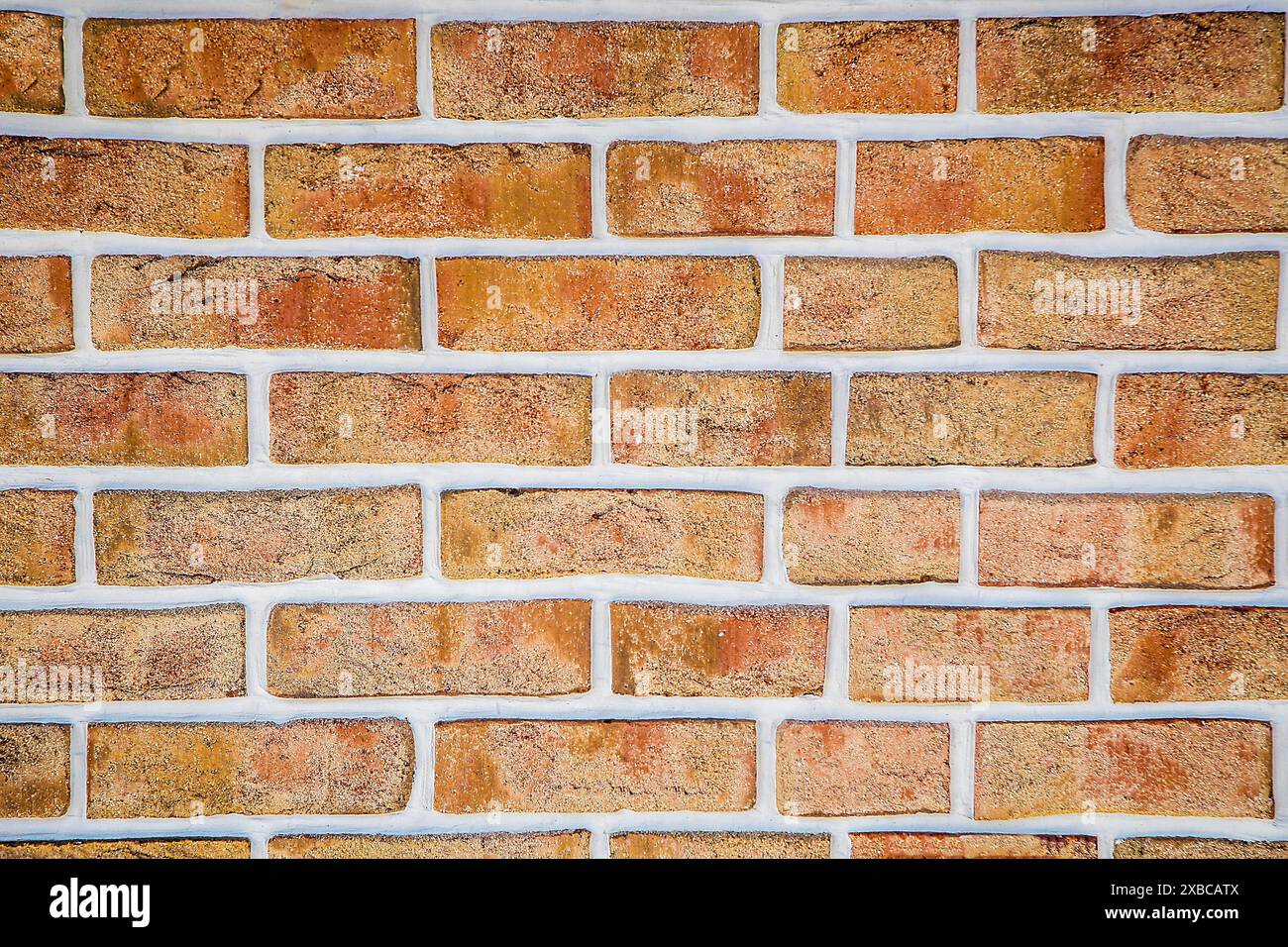 A close-up view of a brick wall with red and orange bricks, showcasing ...