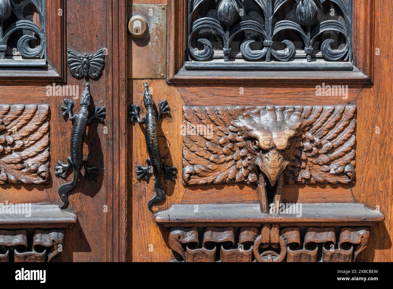 Detail, entrance door with gecko door handles and wood carvings in the ...