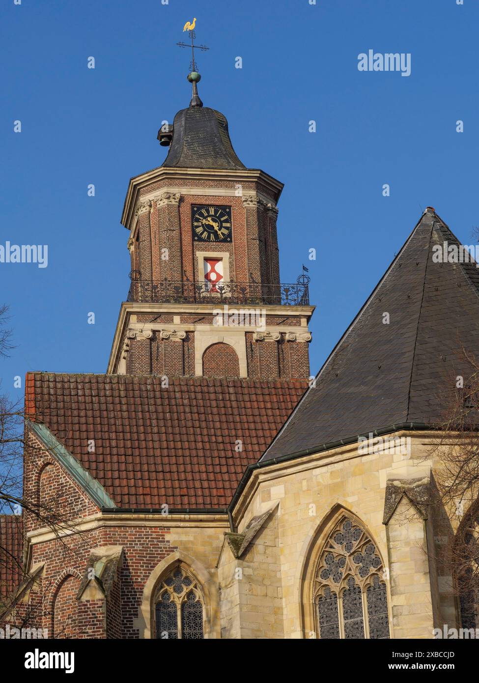 An attractive church tower with clock and historic brick details under ...