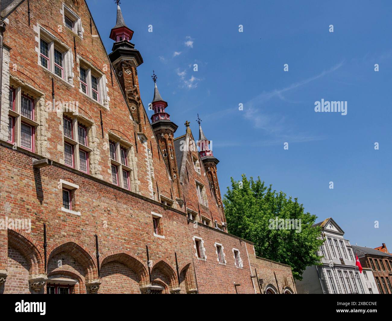 Majestic historic brick buildings in Gothic style under a clear blue ...