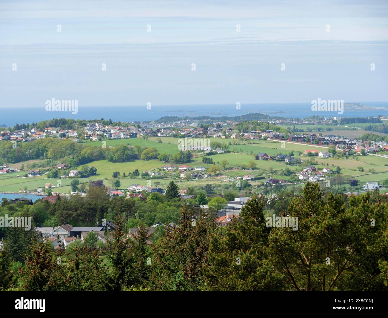 View of a small village with green hills and scattered houses near the ...
