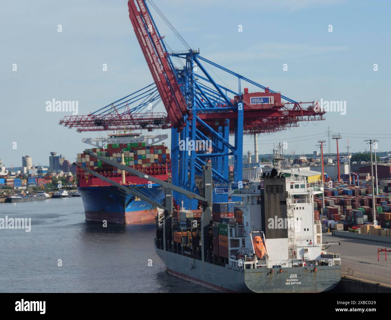 Large container cranes loading cargo ships in the harbour, many ...