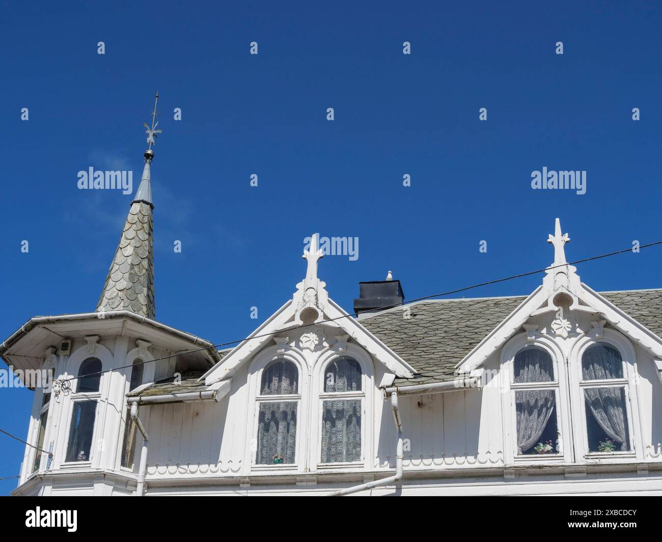 Historic building with a tower and many windows in front of a clear ...