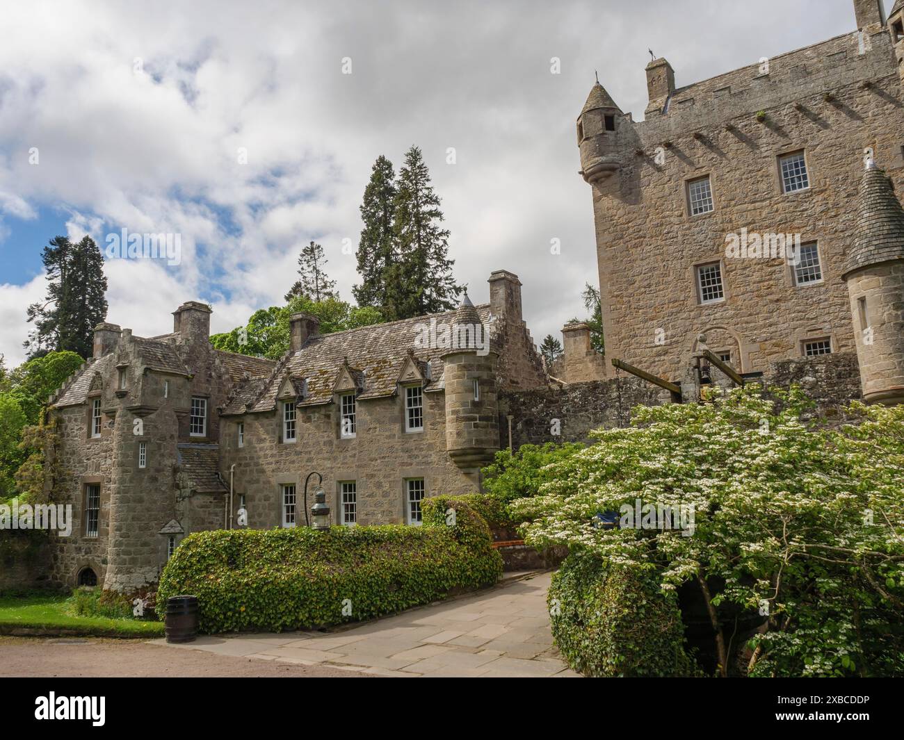 An impressive castle with turrets under a partly cloudy sky, inverness ...