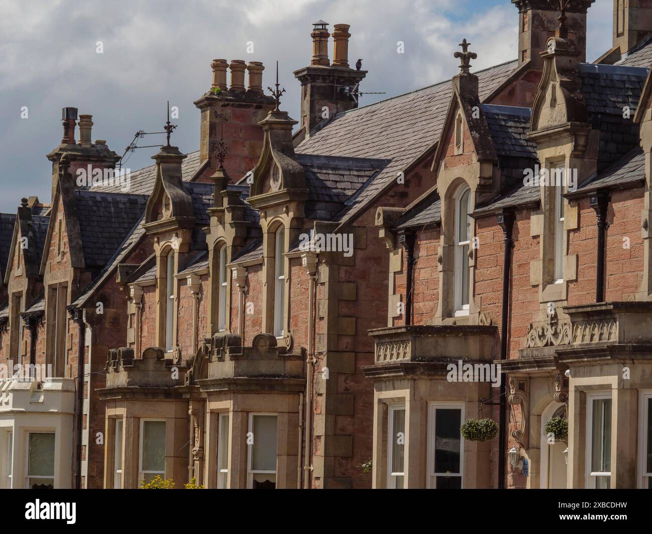 Historic buildings with stone facades and chimneys standing under a ...