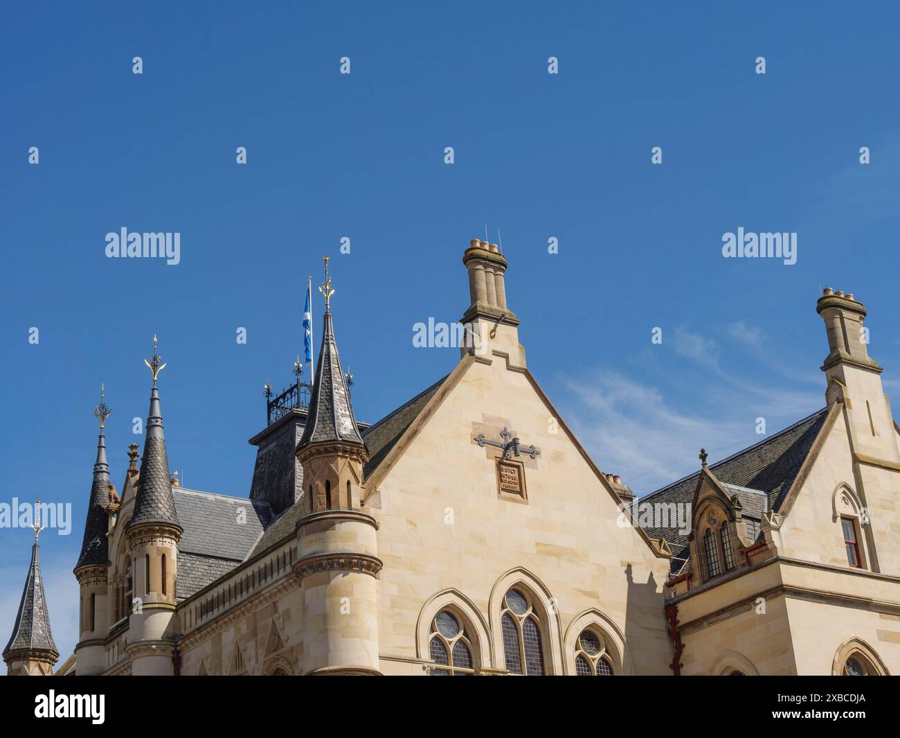 A historic Gothic-style building with towers and stone decorations ...