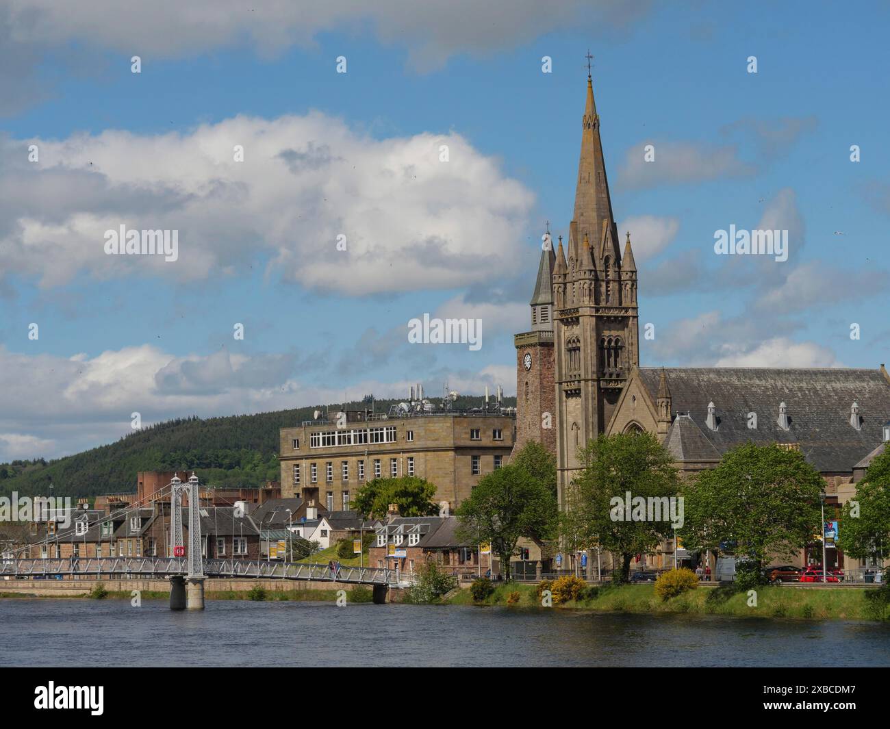 Large church tower and municipal buildings next to a bridge over a ...