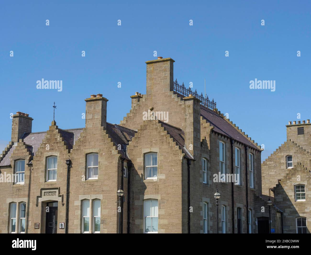 Historic brick buildings with chimneys and windows, shot under a clear ...