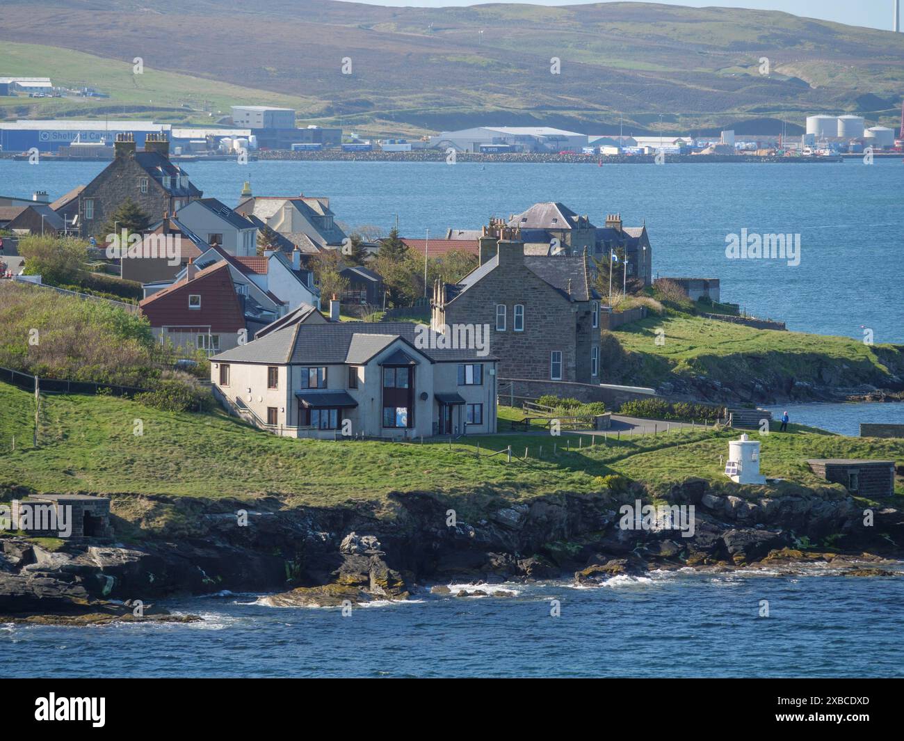 Coastal landscape with various houses and a village overlooking the sea ...