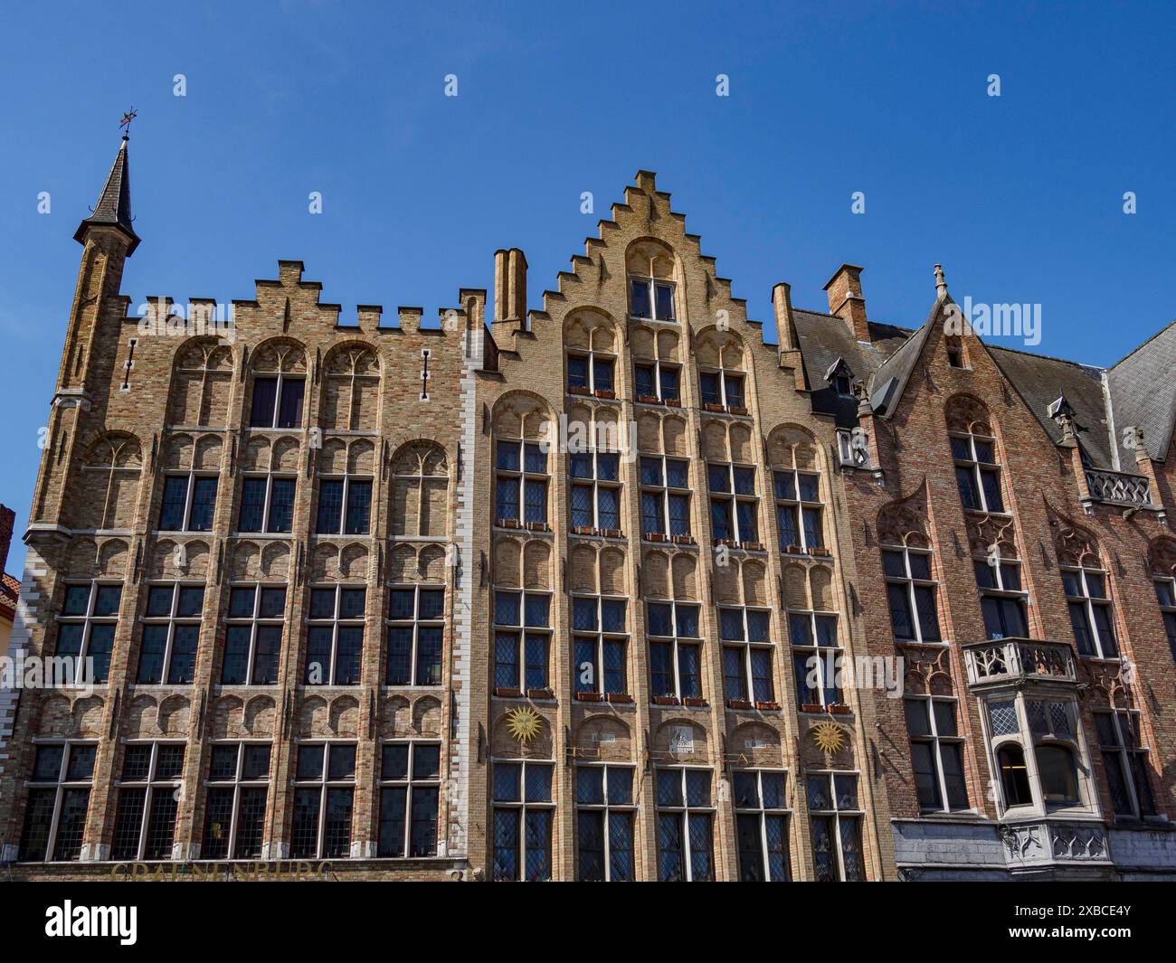 Historic Gothic-style buildings with jagged facades under a clear blue ...