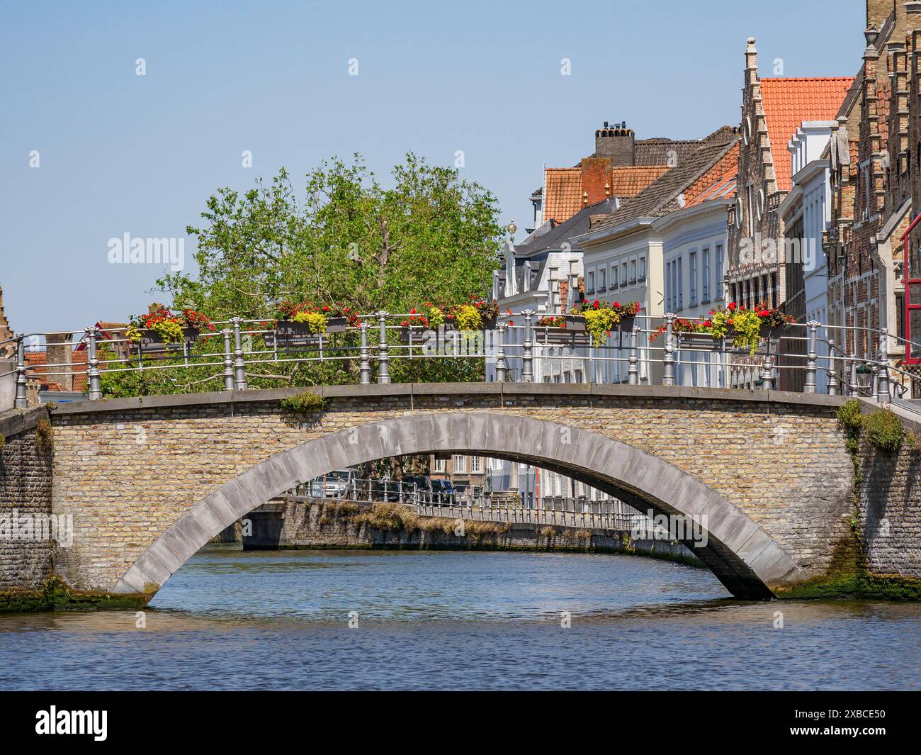 Stone bridge over a canal, decorated with flower boxes and historical ...