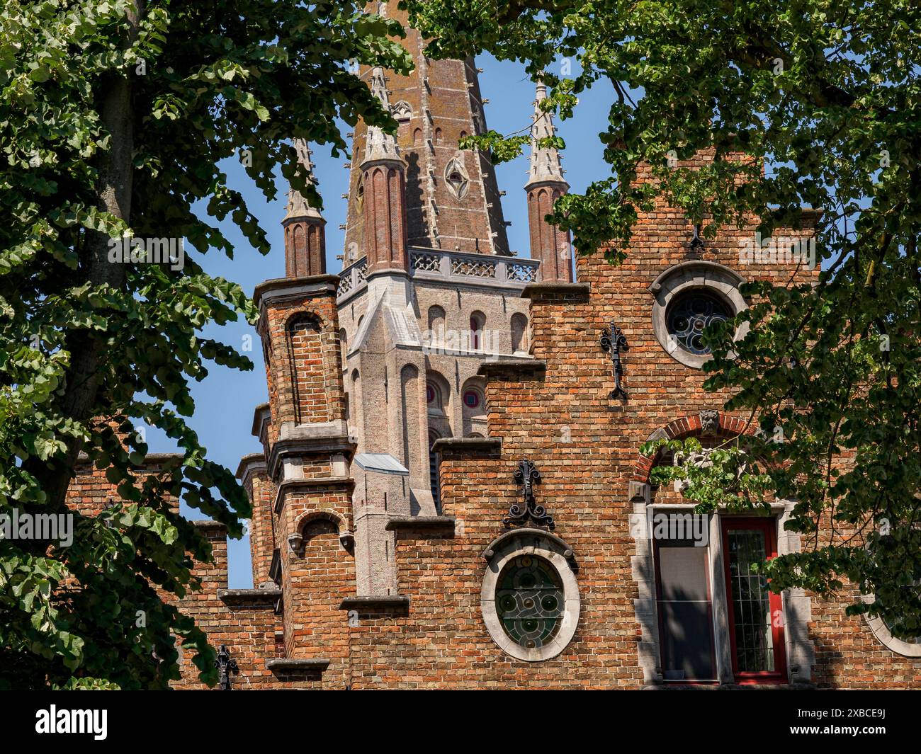 Gothic architecture with towers and arched windows, surrounded by green ...