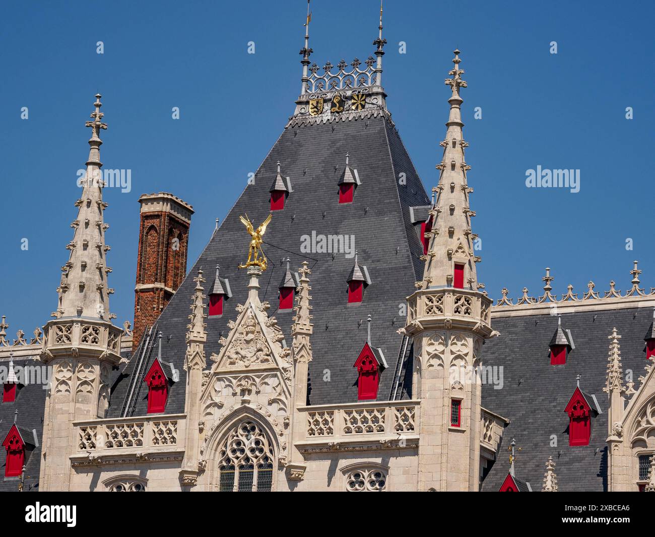Detailed Gothic architecture with high towers and red windows against a ...