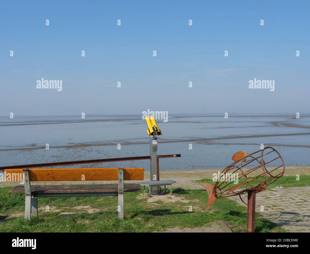 Viewing platform with bench, yellow telescope and a fish sculpture with ...