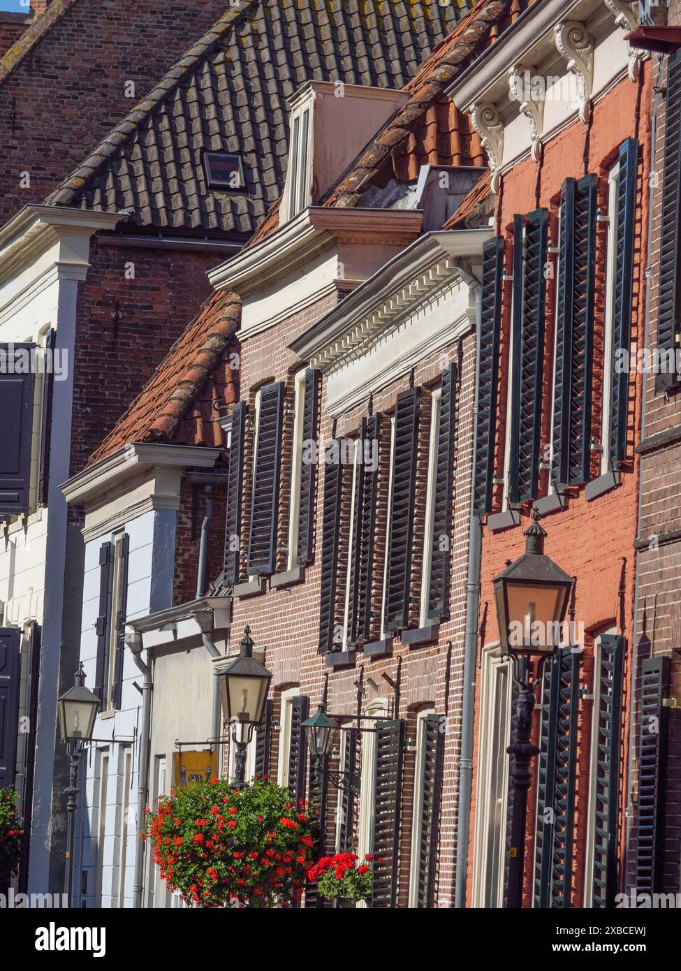 Row of historic brick houses with white lattice windows, lanterns and ...