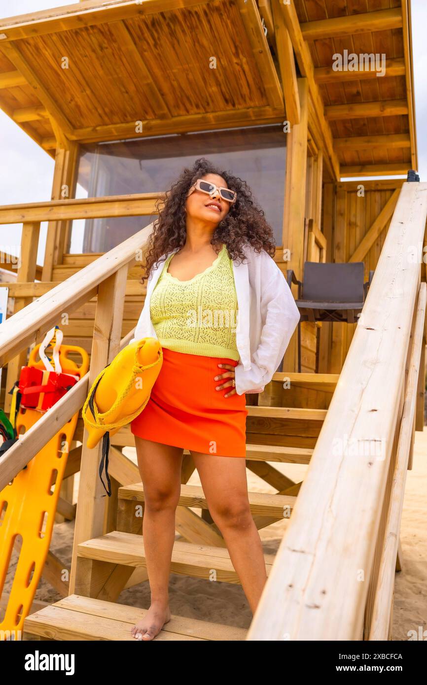 Portrait of woman on lifeguard tower enjoying summer on vacation on ...
