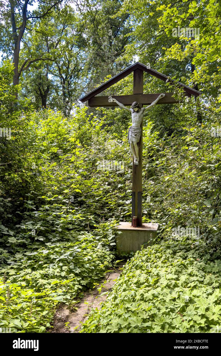 Old roofed cross with figure of Jesus Christ crucified on the cross at ...
