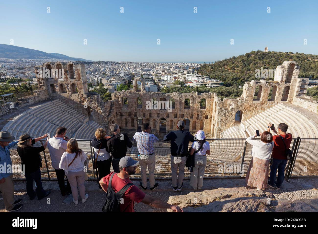 Tourists looking at the Odeon of Herod Atticus, Roman-Greek ...